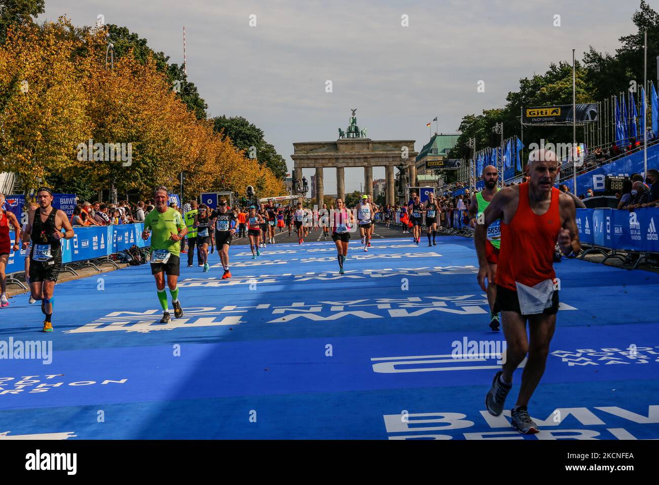 Participants run in front of Brandenburg gate as thousands of people ...