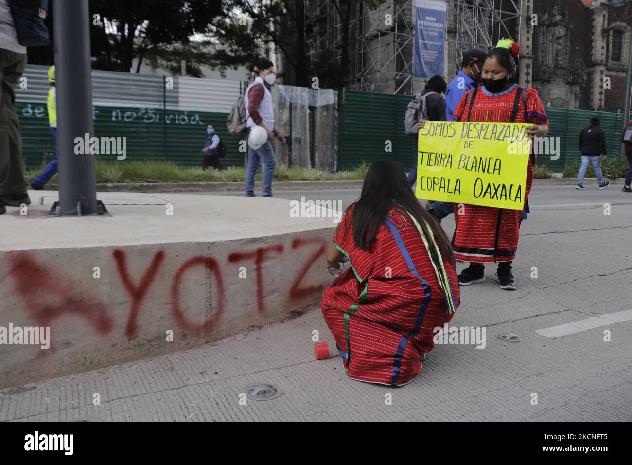A woman from the indigenous Triqui community makes some graffiti in the ...