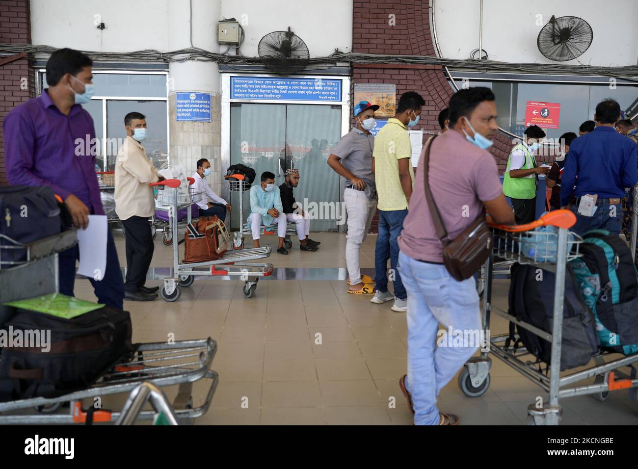 Migrant workers wait for flights outside Hazrat Shahjalal International ...