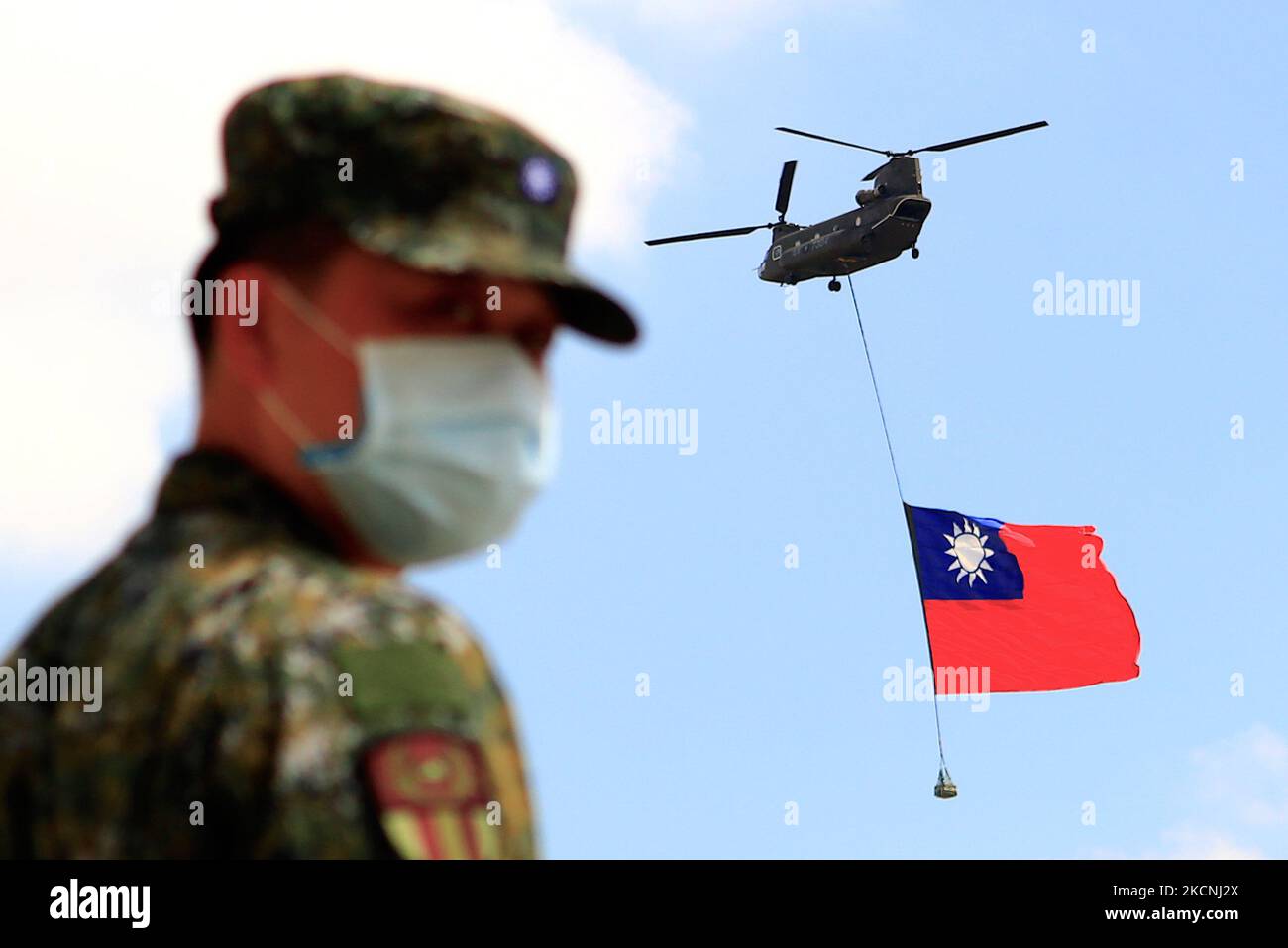 A Chinook Helicopter carrying the biggest Taiwan flag ever flies over a ...