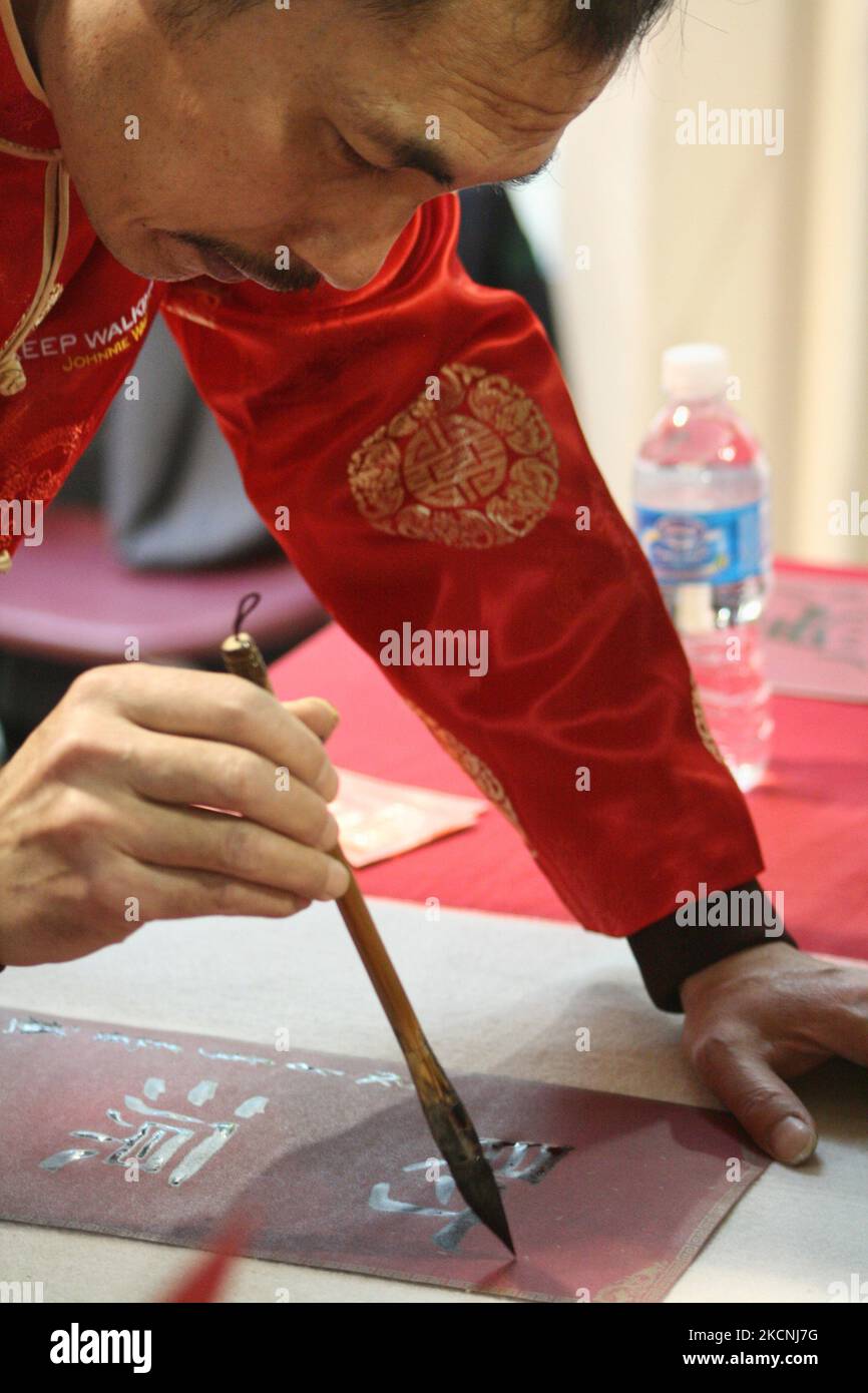 Chinese man demonstrates traditional Chinese calligraphy during Chinese ...