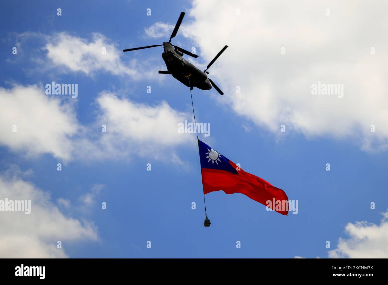 A Chinook Helicopter carrying a tremendous Taiwan flag flies over a ...