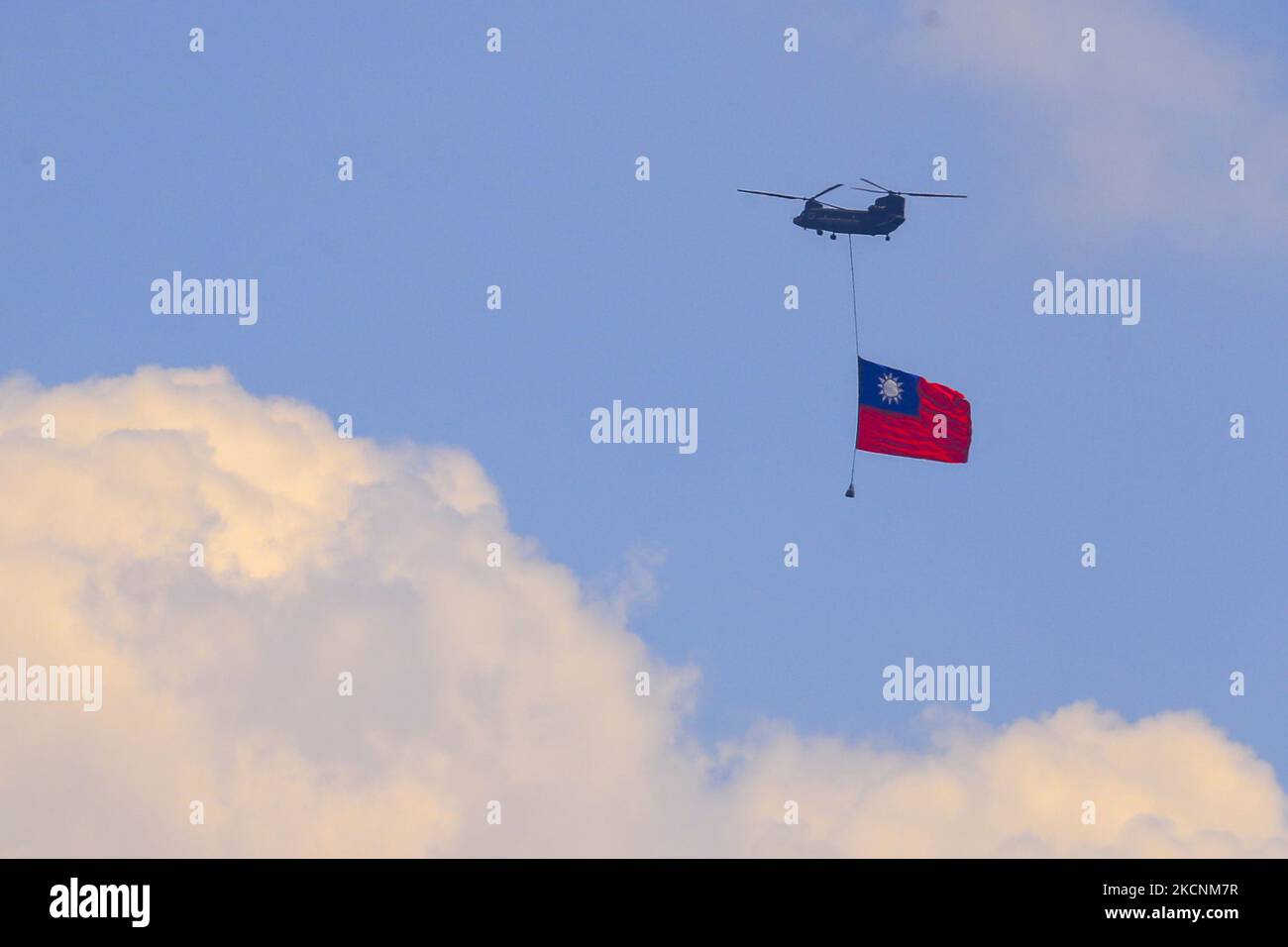 A Chinook Helicopter carrying a tremendous Taiwan flag flies over a ...
