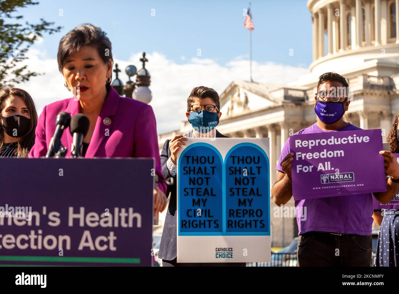 Jamie Manson of Catholics for Choice holds a sign that resembles ...