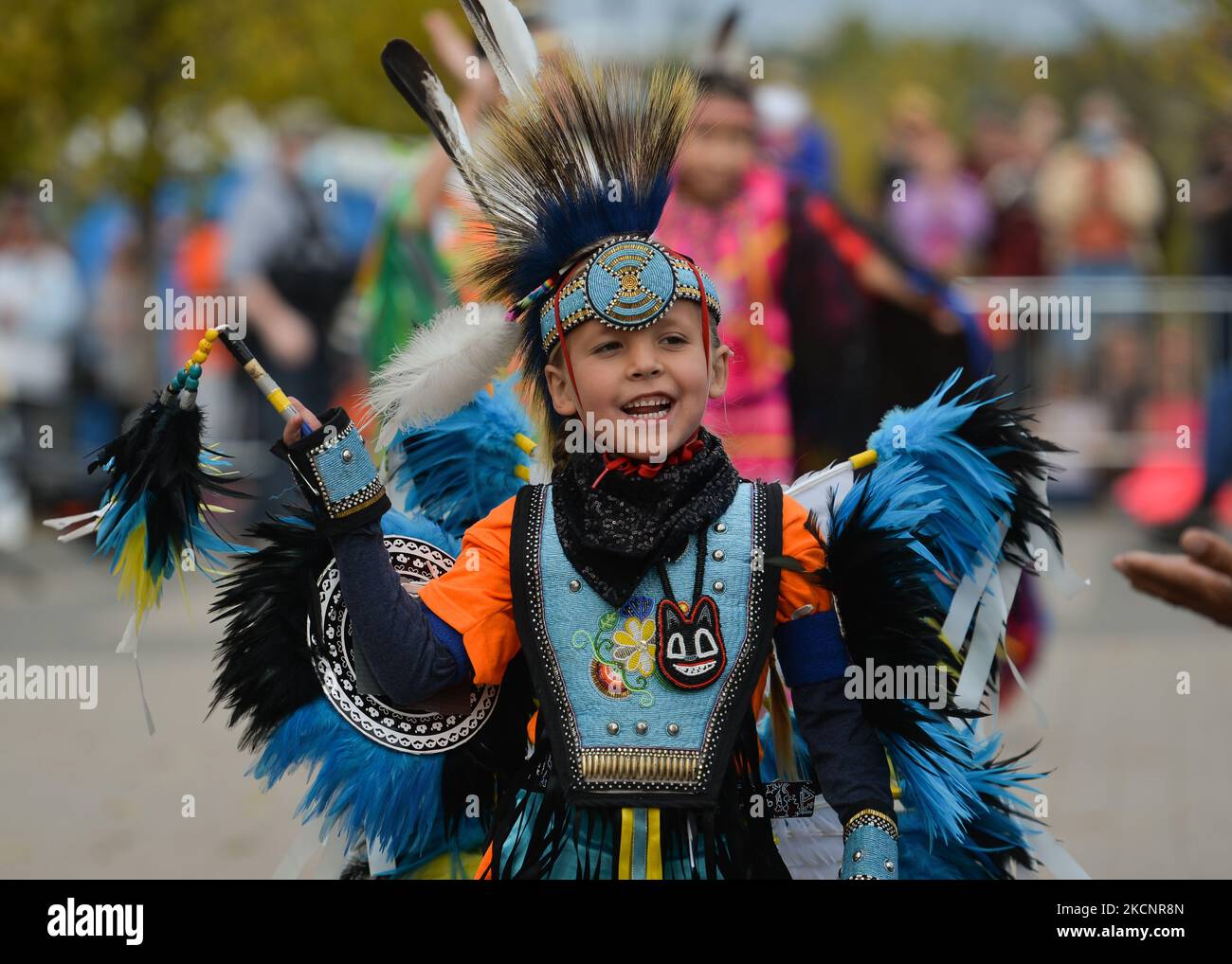 A young member of the First Nations performs an indiginius dance as the ...