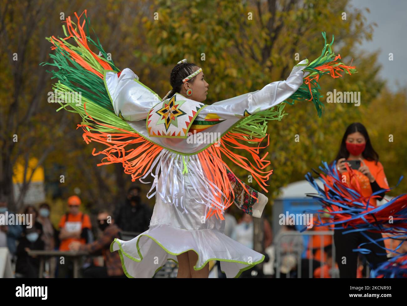 A young member of the First Nations performs an indiginius dance as the ...