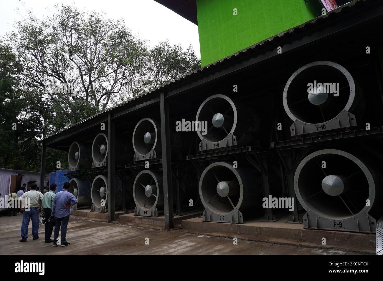 Media officials stand next to recently installed 25-metre high smog ...