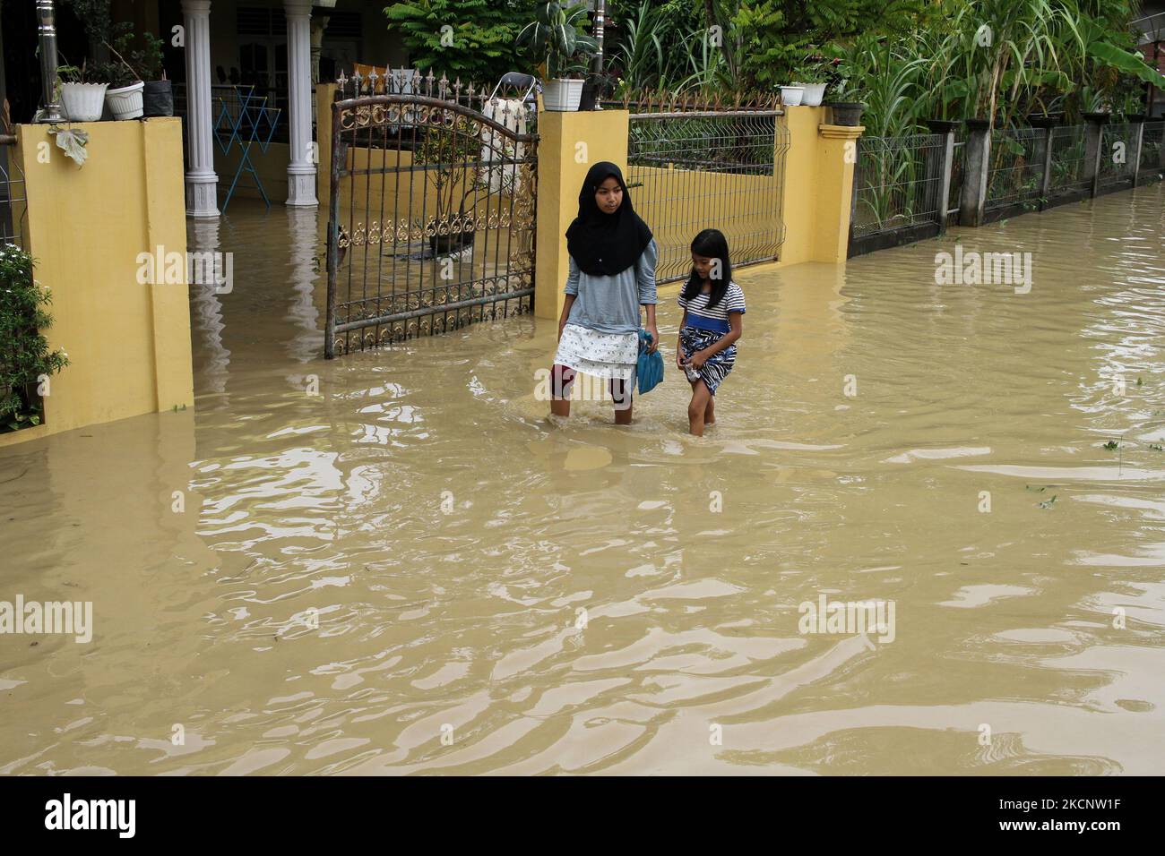 A child is seen walking through a flood caused by a river overflowing ...