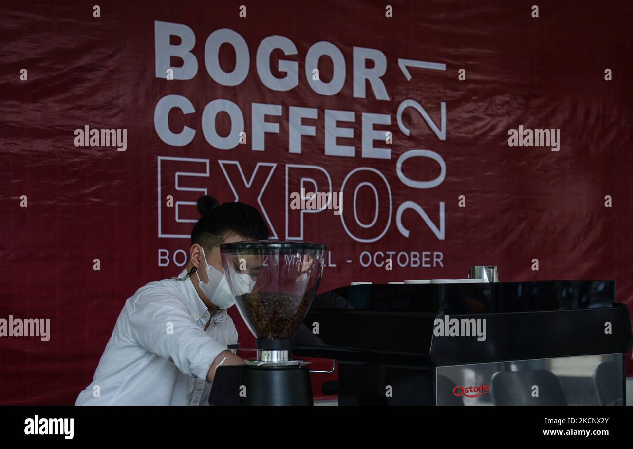 A Barista prepares coffee drinks during a competition Bogor Coffee Expo ...