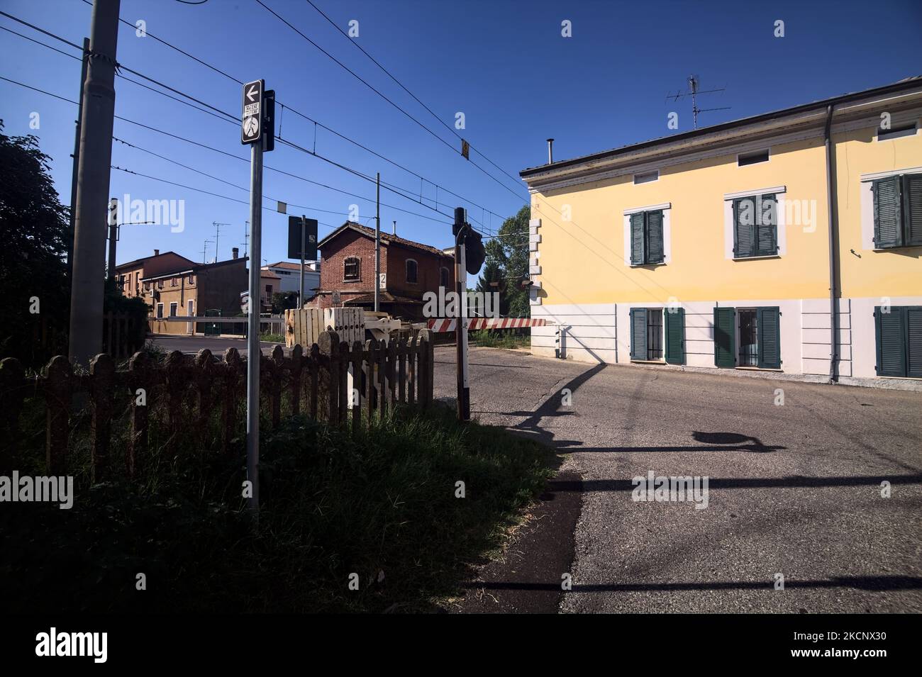 Railroad crossing in an italian town at sunset Stock Photo - Alamy