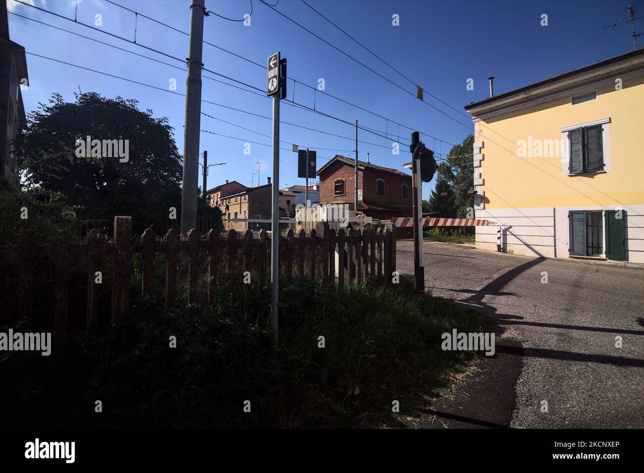Railroad crossing in an italian town at sunset Stock Photo - Alamy