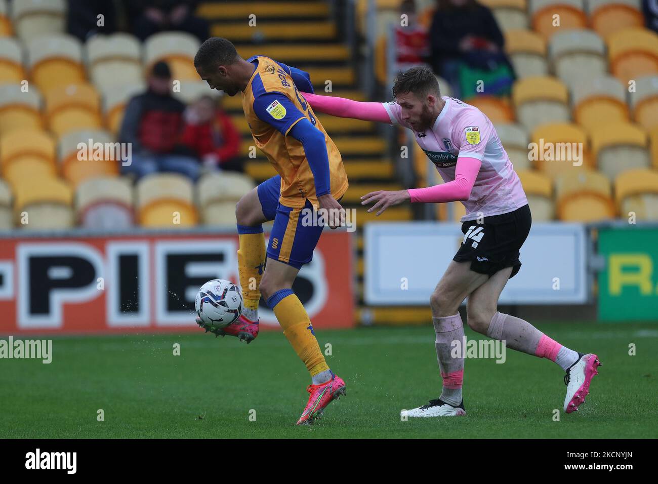 . Mansfield Town's Jordan Bowery in action with Barrow's James Jones ...