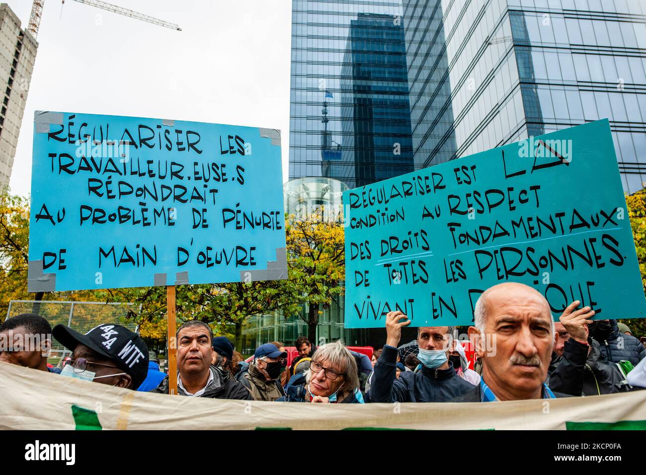 People are holding placards in support of illegal immigrants while ...
