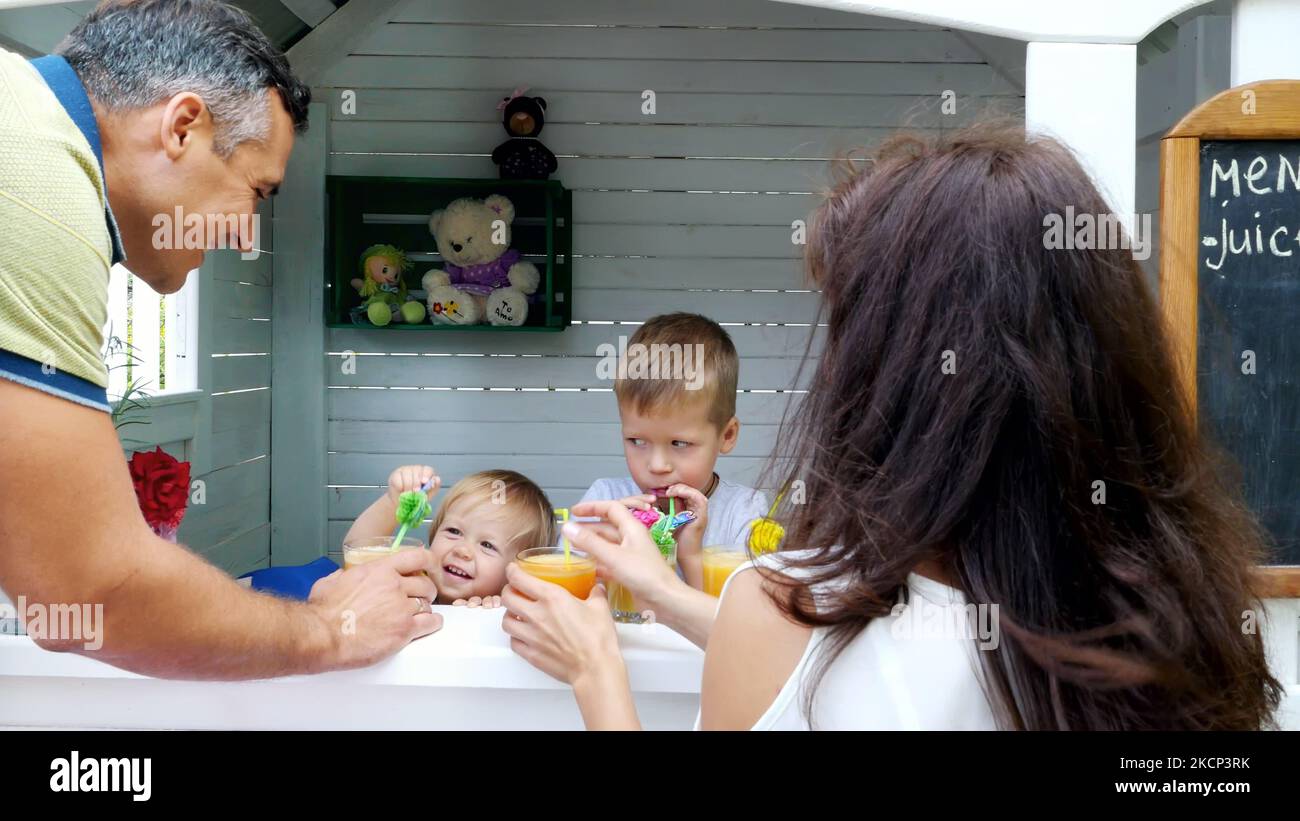 summer, in the garden, parents, mom and dad, carry freshly squeezed ...