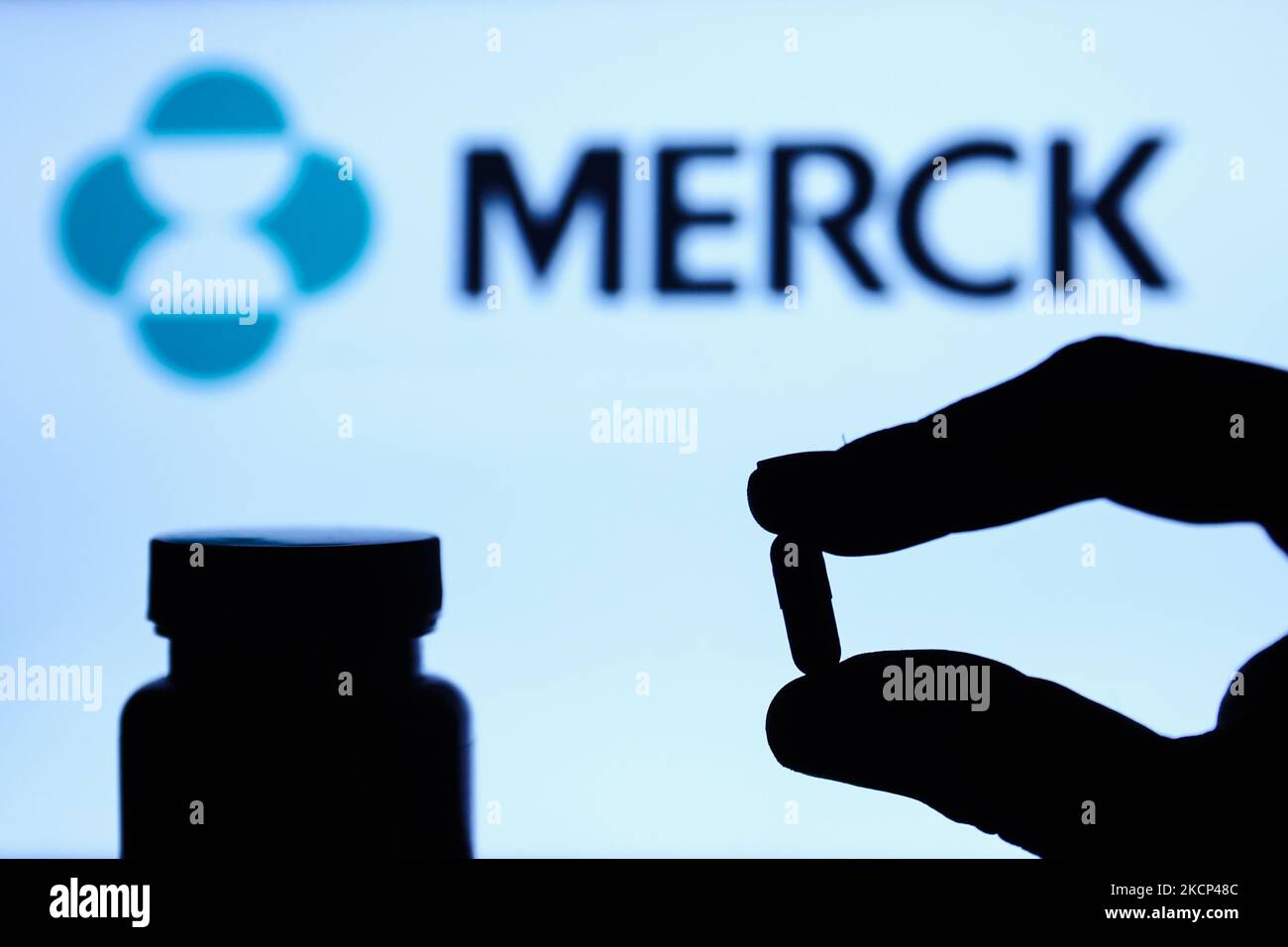 Medicine pill is seen with Merck logo displayed on a screen in the ...