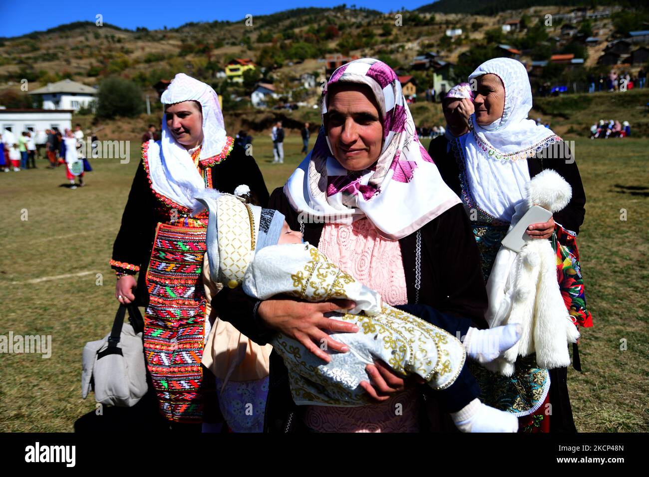 Pomak woman holds a baby before traditional circumcision ritual in ...