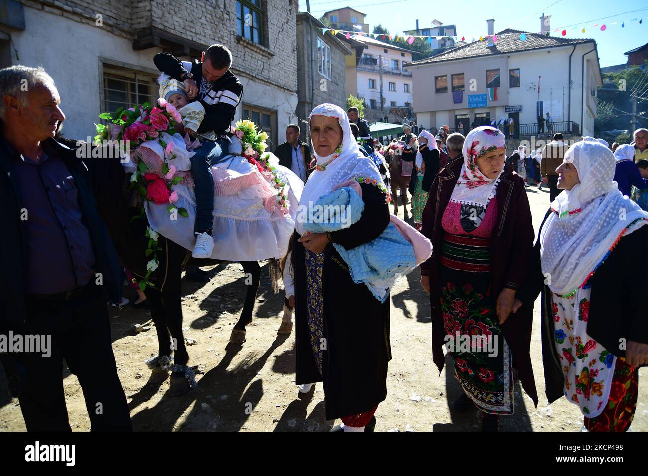Women with traditional pomak clothing standing next to baby boy on a ...