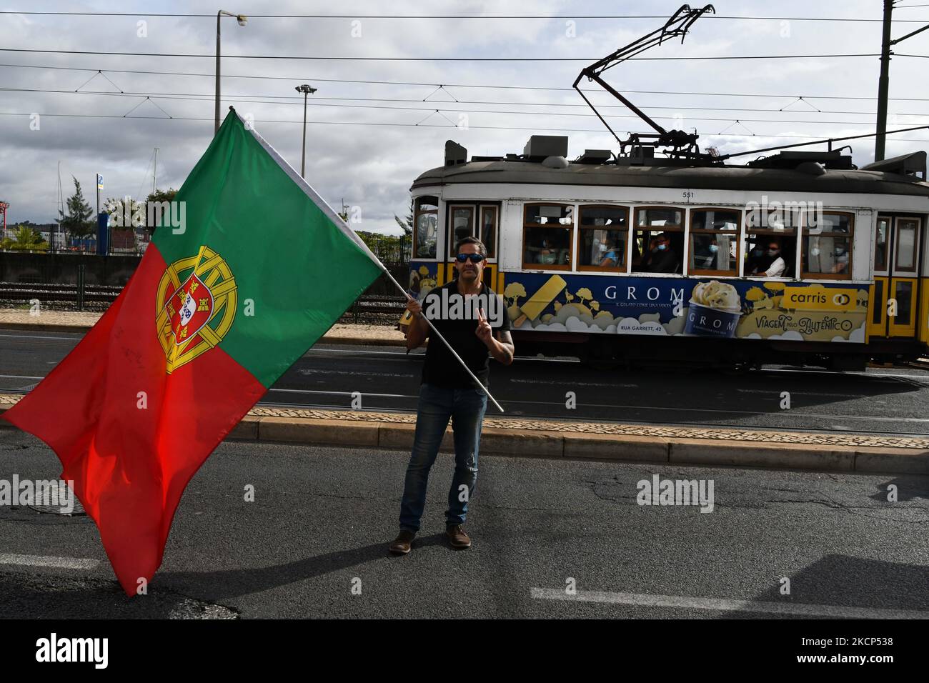 A teachers' union activist unfurls a Portuguese flag during a march in Lisbon. 05 October 2021 ...