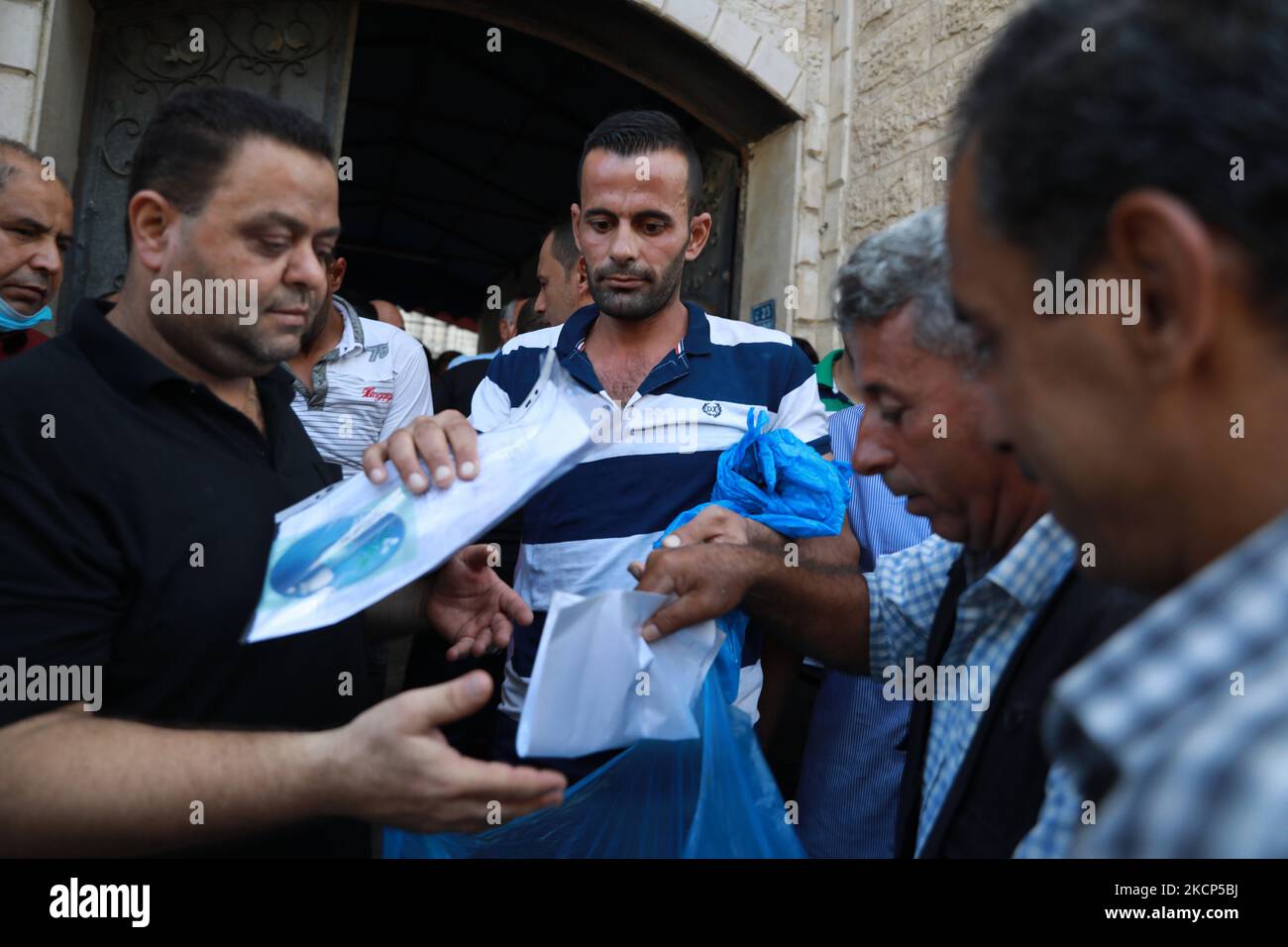 Palestinian men gather to apply for work permits in Israel, at Jabalia ...