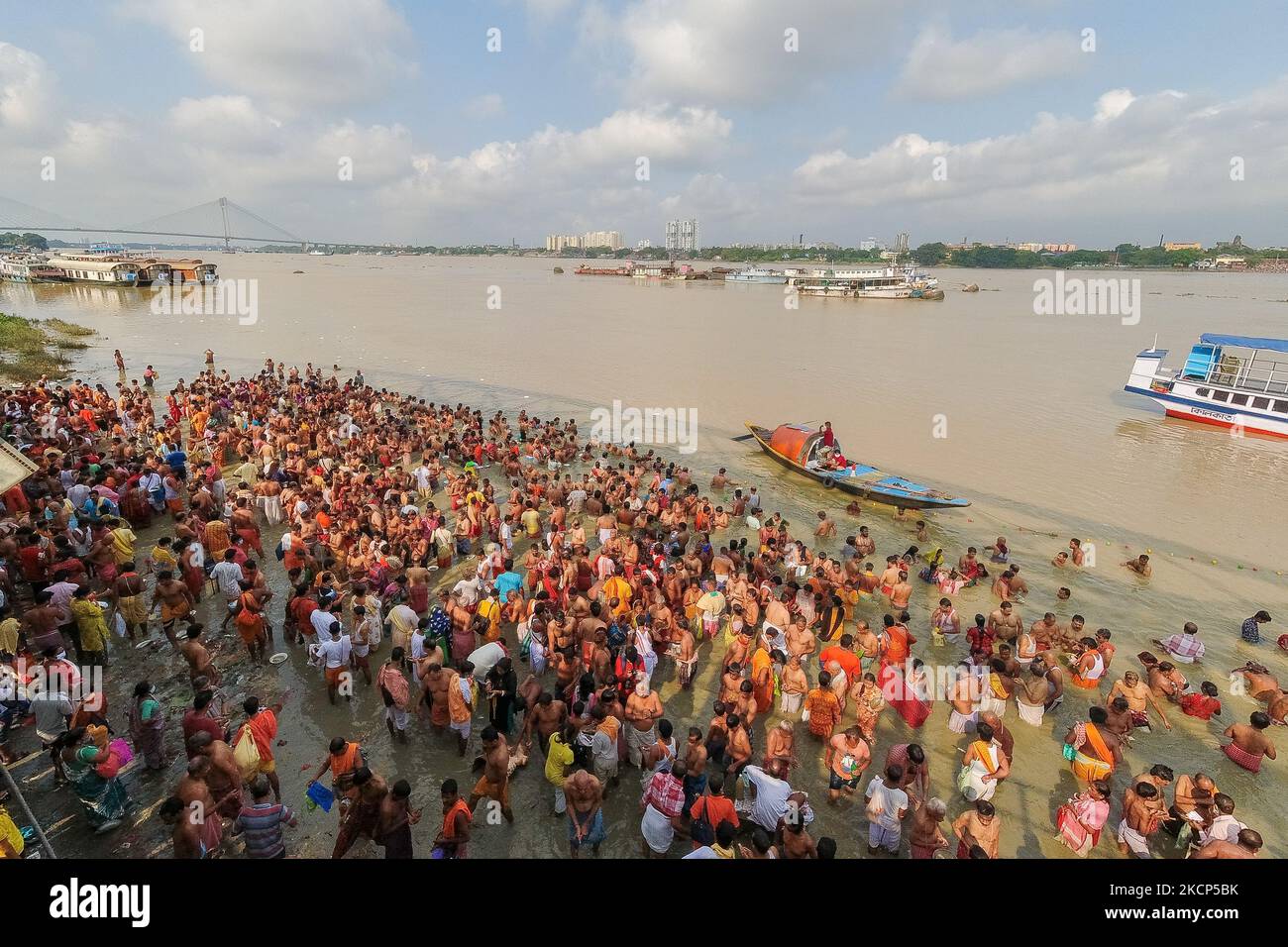 Hindu devotees are seen crowding a Ganges riverside to offer prayers ...