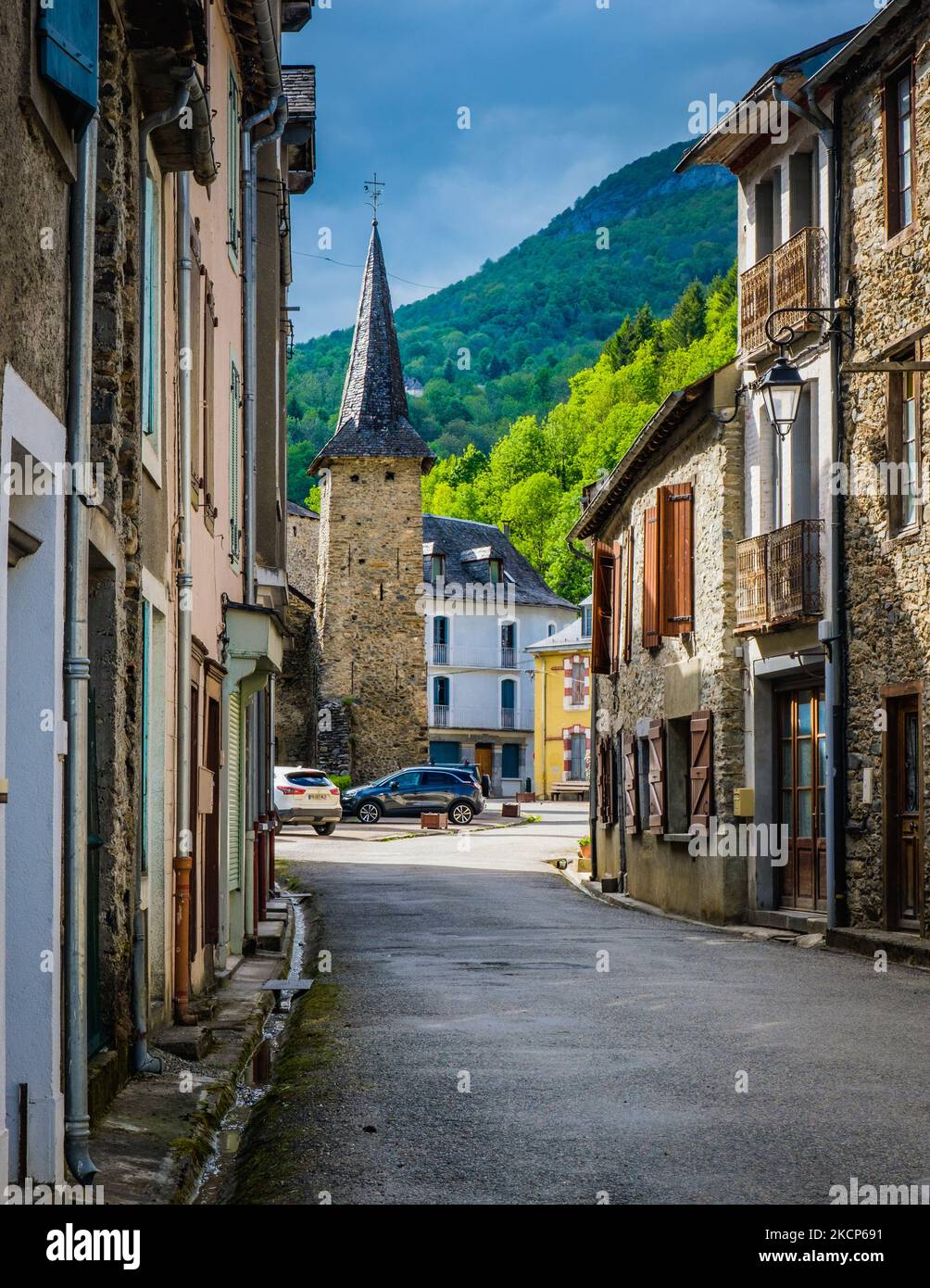 The street of the small village of Sentein with view on the church bell ...