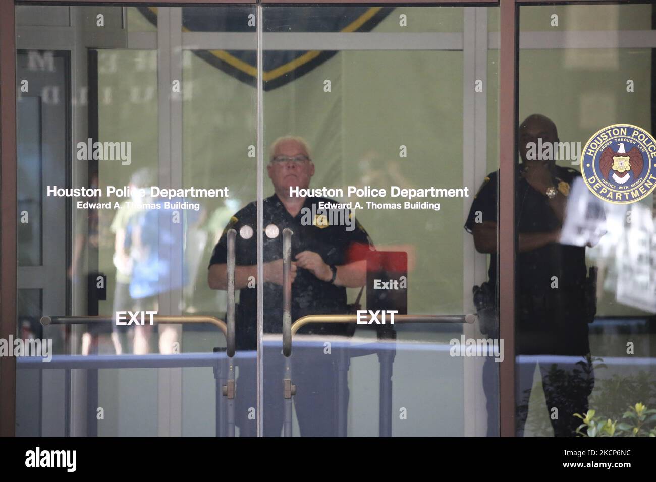 The police watch through the front lobby of the Houston Police ...