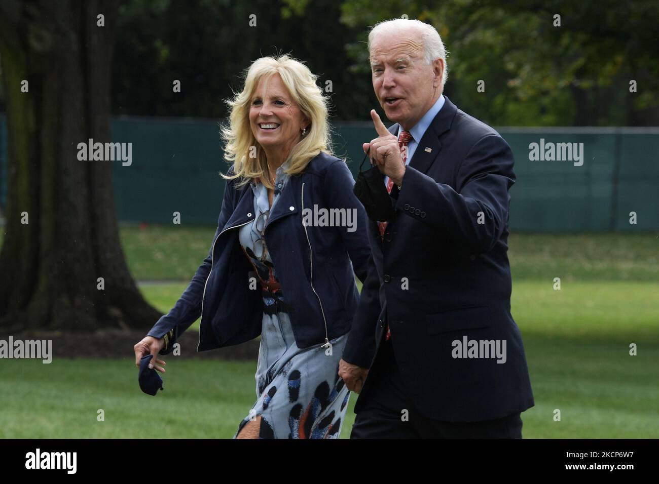 US President Joe Biden and First Lady Jill Biden walk through South ...