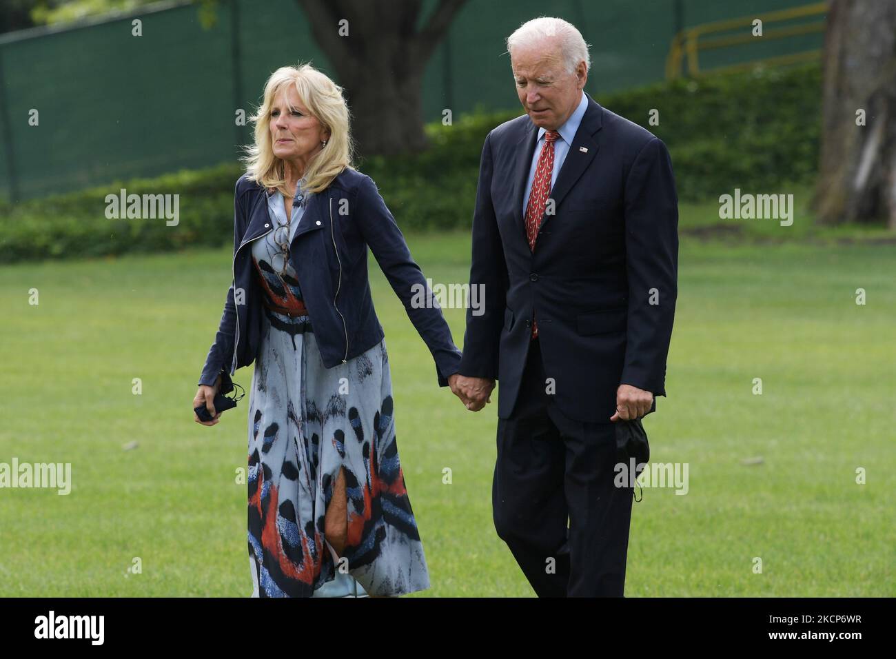 US President Joe Biden and First Lady Jill Biden walk through South ...