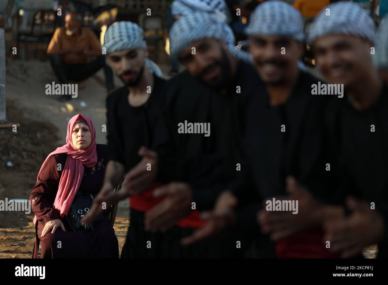 Palestinians participate in a wedding simulating traditional ...