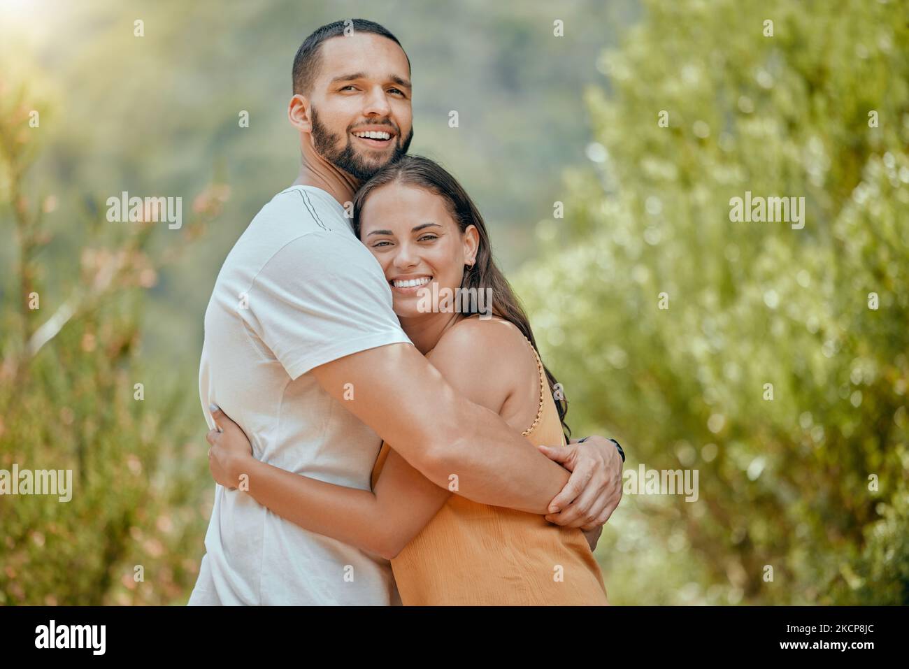 Black couple, hug and smile in woods together, outdoor and bush with ...