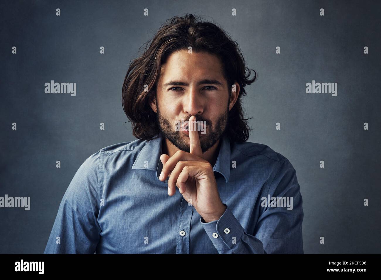 Can you keep a secret. Studio portrait of a handsome young man posing ...