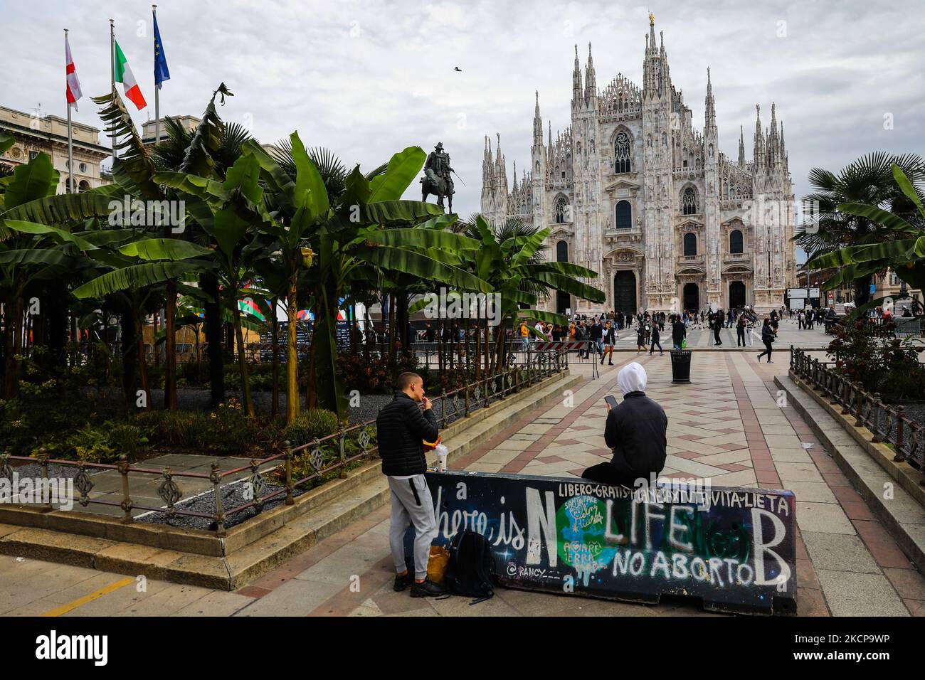 Protest slogans are seen on a wall at the Piazza del Duomo in Milan ...