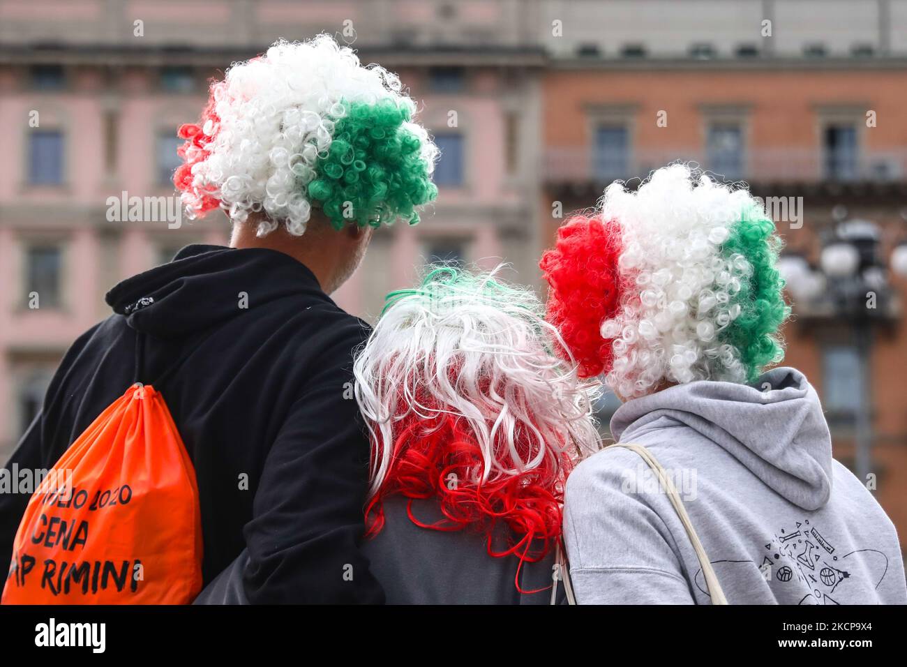 Football fans wearing wigs in the colors of the Italian flag pose for a ...