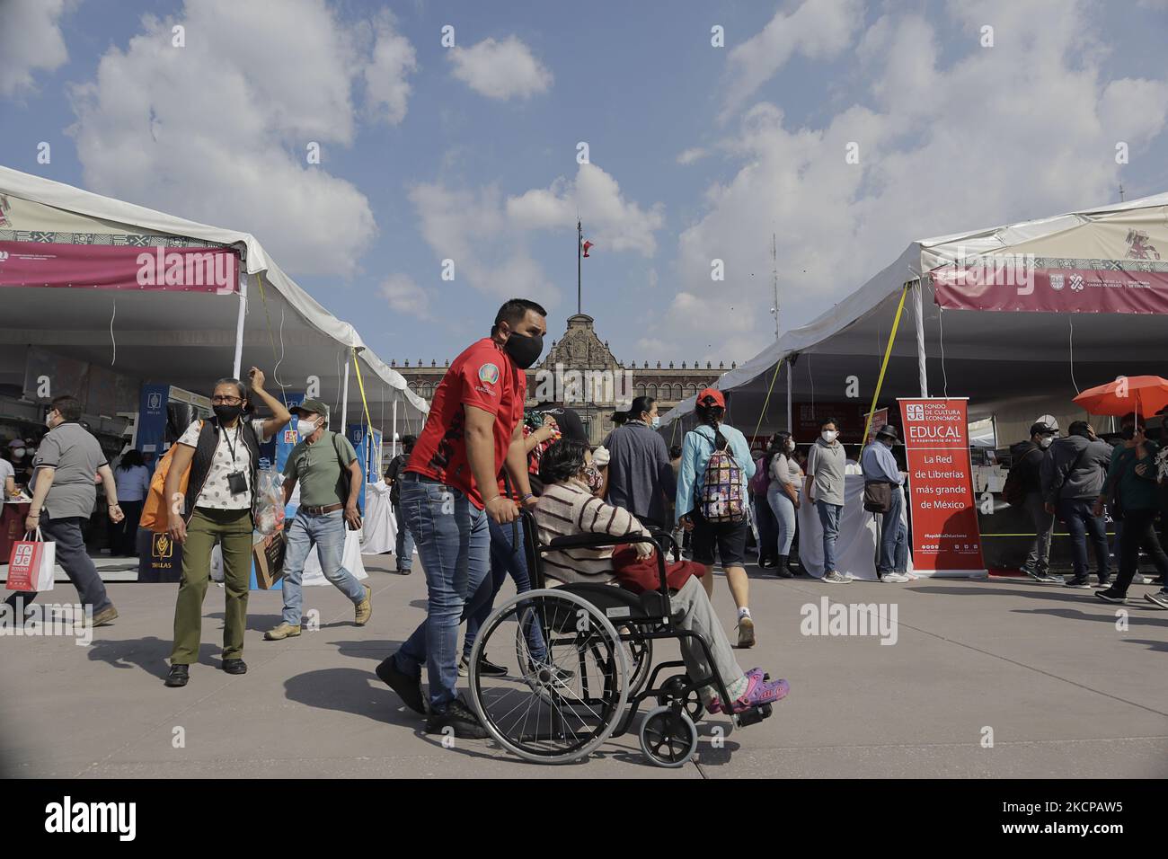A disabled person in a wheelchair inside the International Book Fair in ...