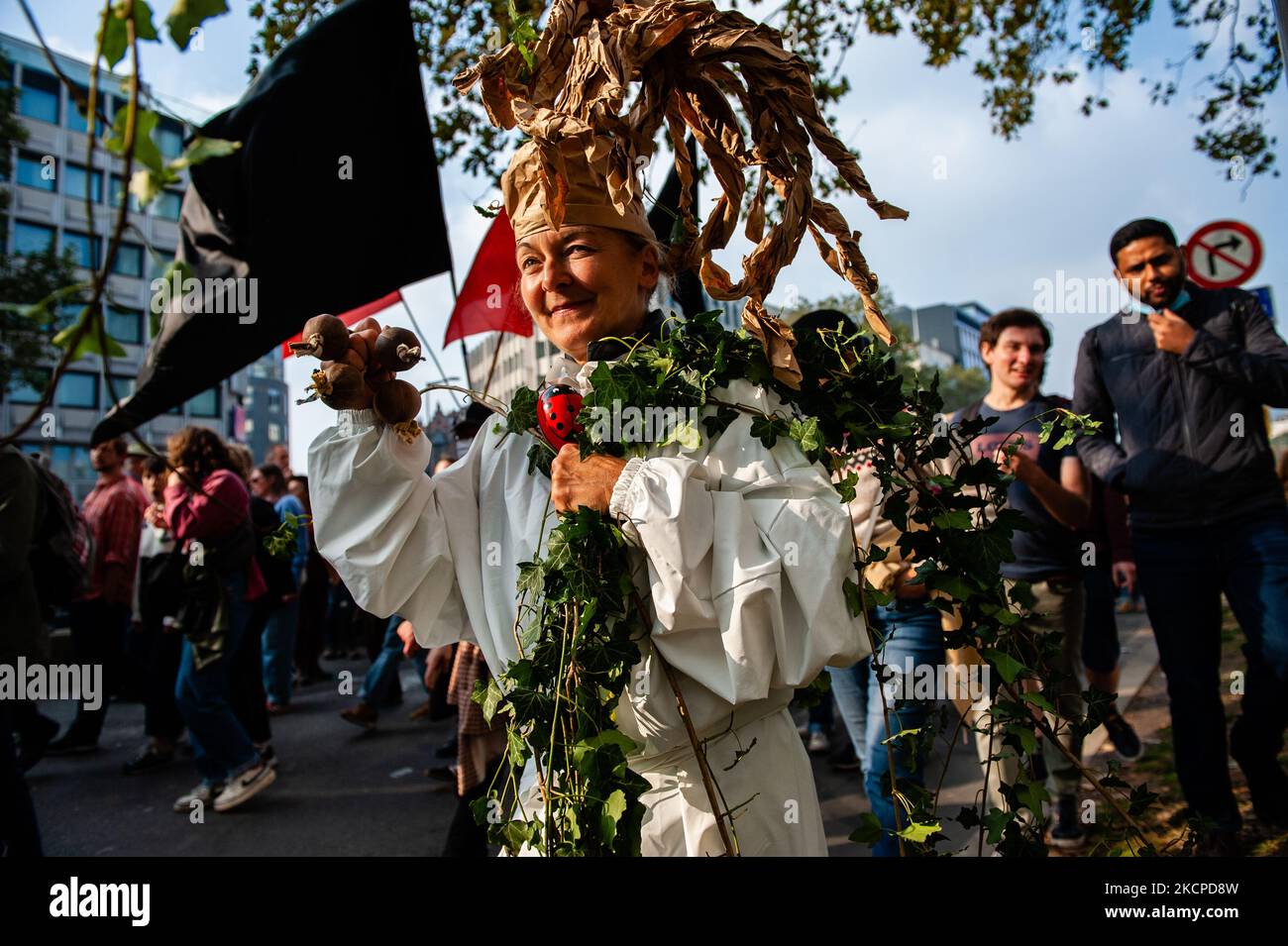 A woman is wearing plants representing mother nature, during the ...