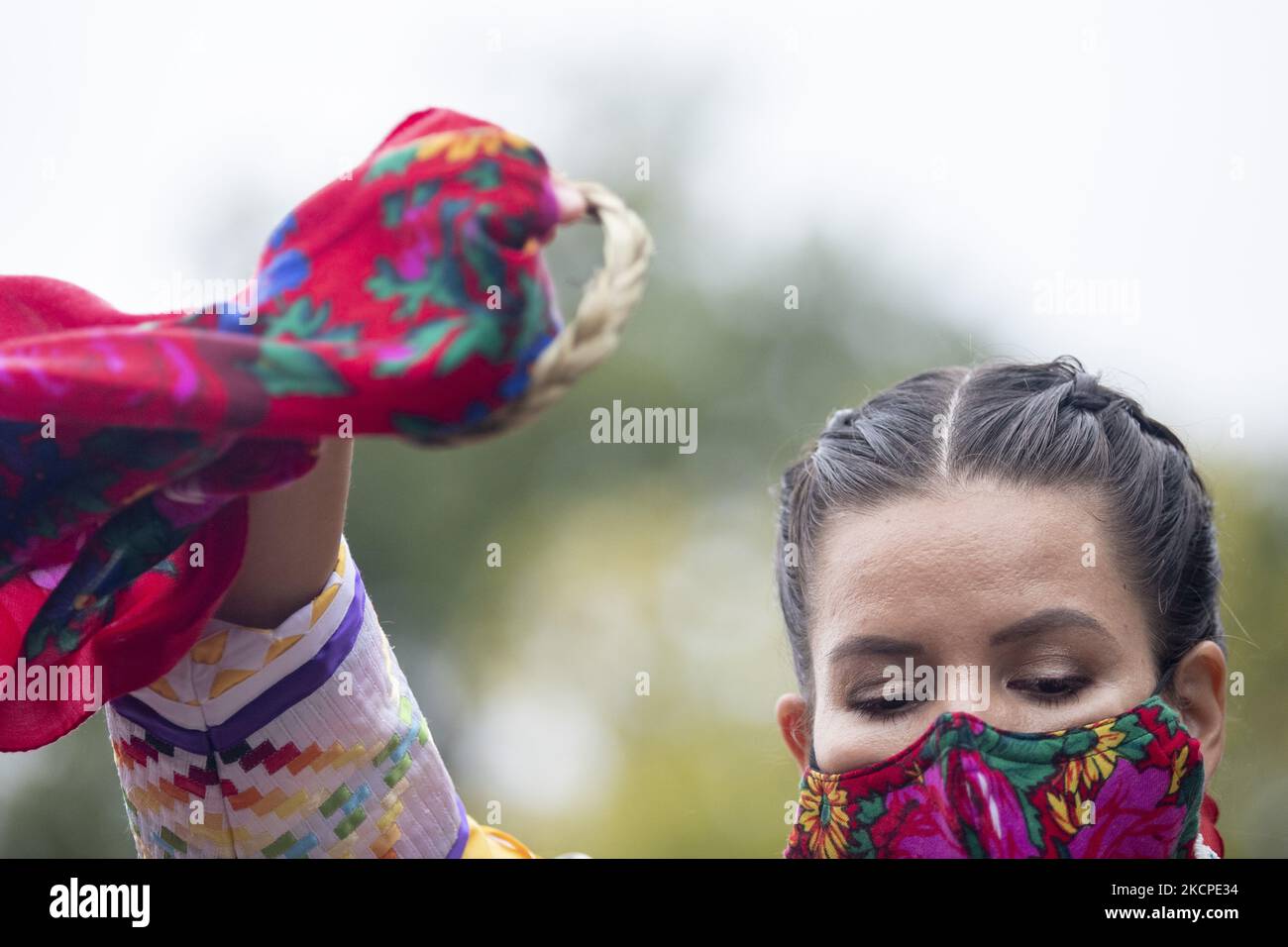 An indigenous woman sings and dances in Lafayette Square Park outside ...