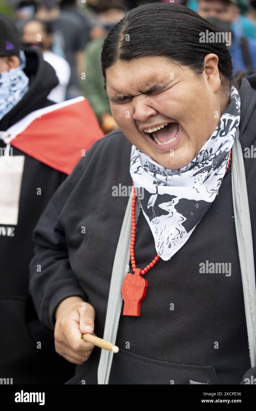 An indigenous man drums and sings in Lafayette Square Park outside of ...
