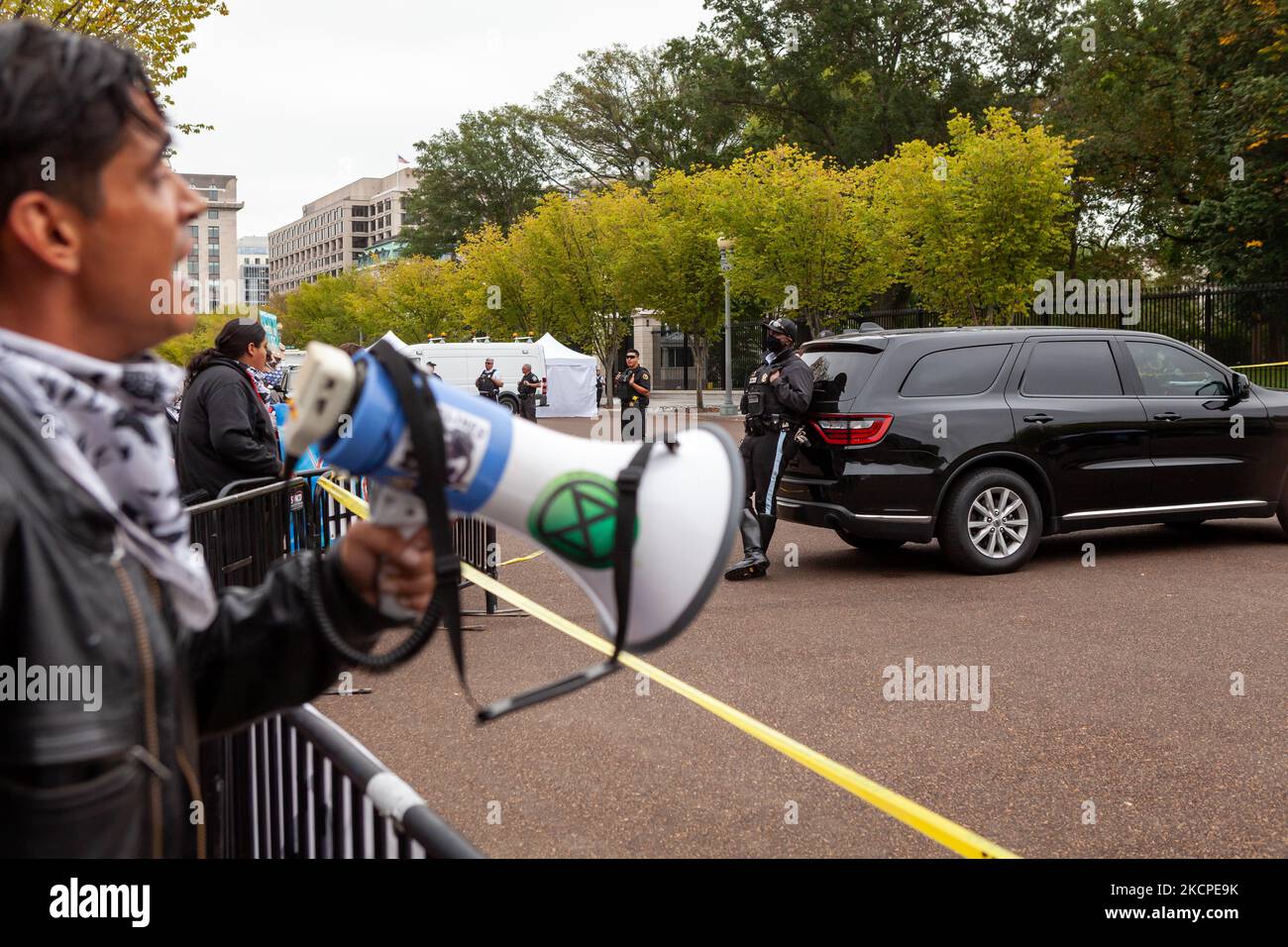 US Park Police officer M.D. Green leans against a car, seemingly ...