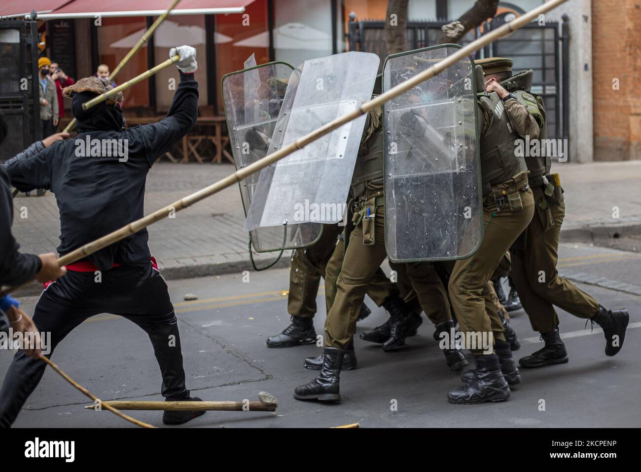 People clash with riot police during a demonstration in Santiago, Chile ...