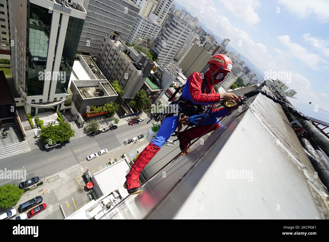 Window cleaners wearing superhero costumes greet a patient at a ...