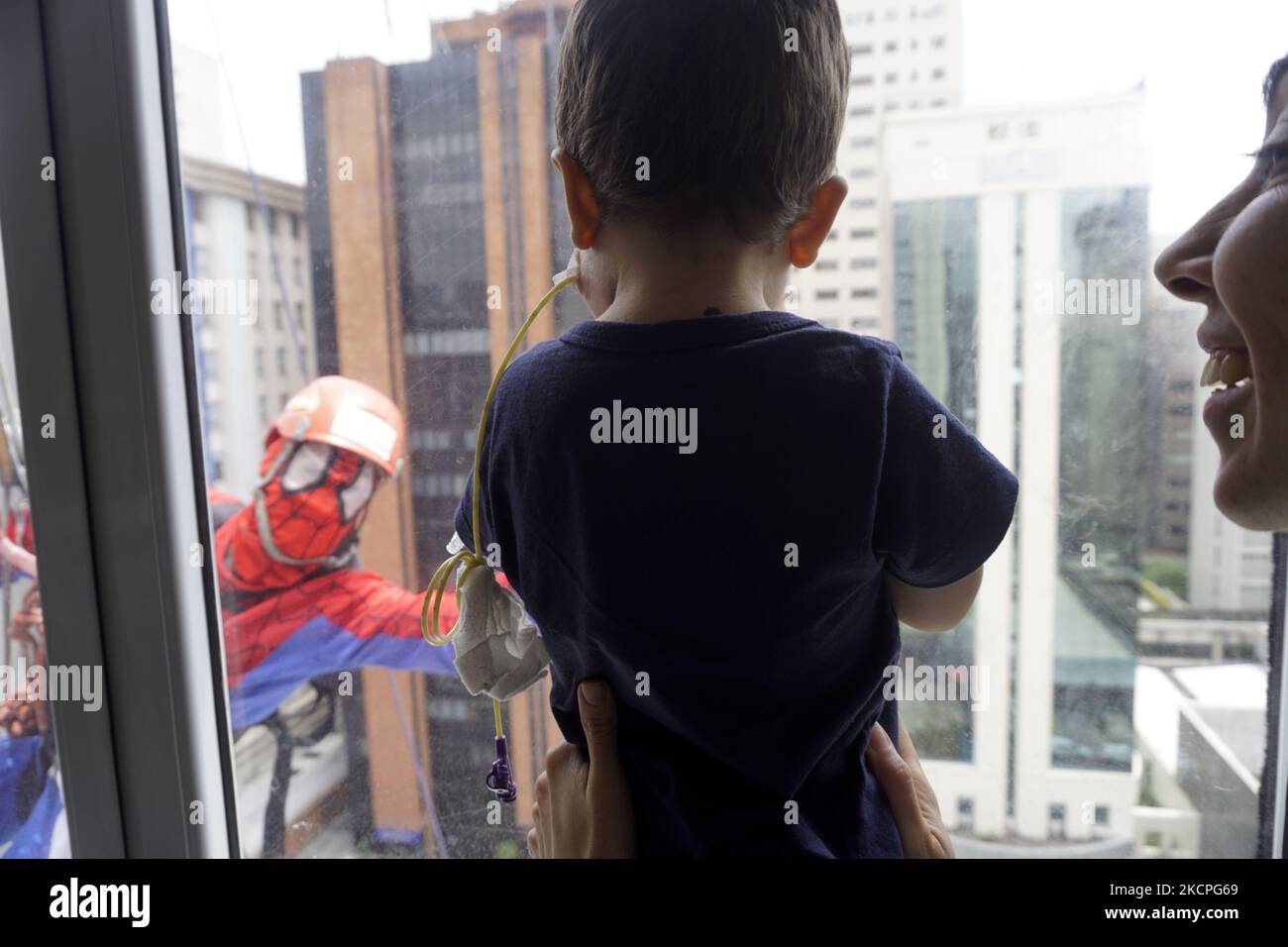 Window cleaners wearing superhero costumes greet a patient at a ...