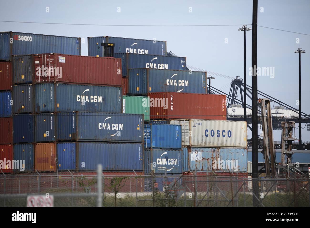 Shipping containers are piled several stories high and as far as the ...