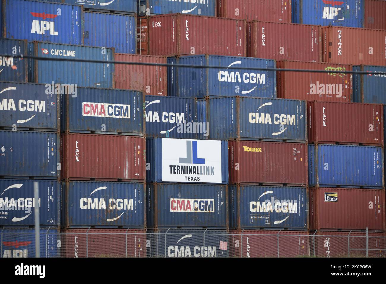 Shipping containers are piled several stories high and as far as the ...