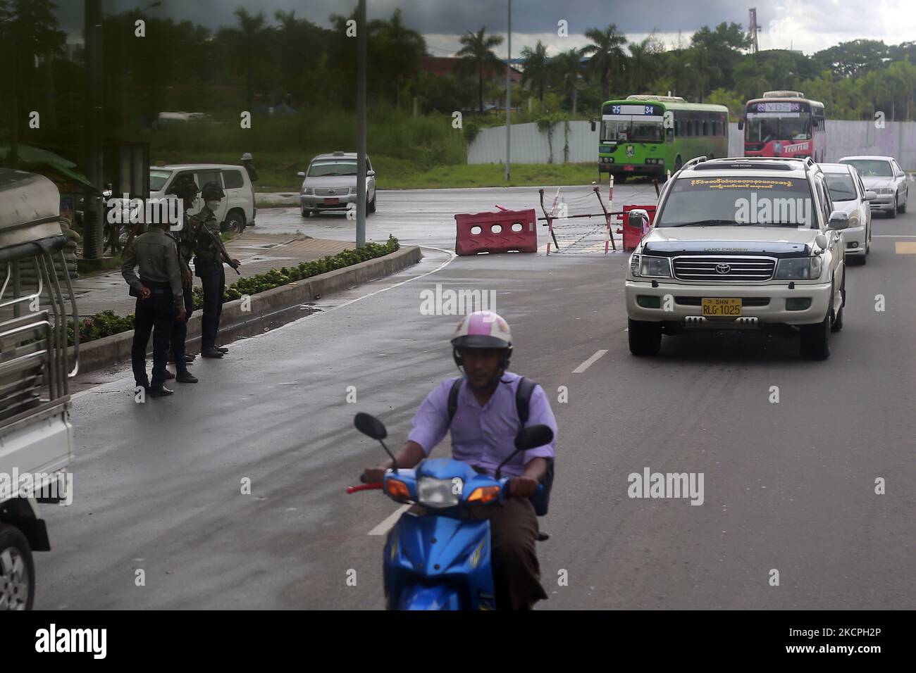 Armed policemen stand guard at a checkpoint on a roadside in Yangon ...