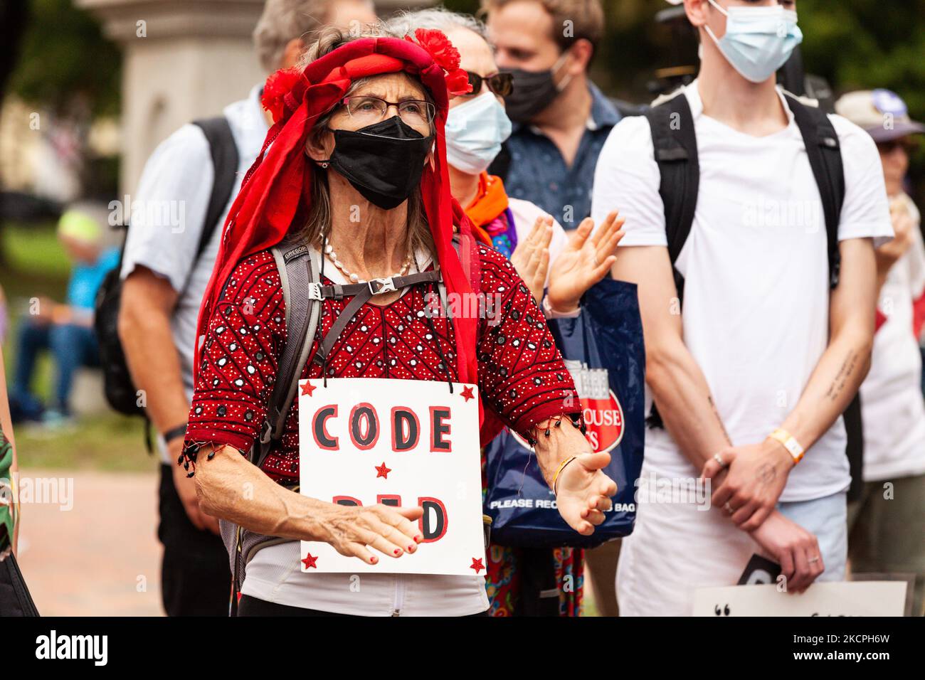 A climate activists holds a climate code red sign as she cheers Native ...