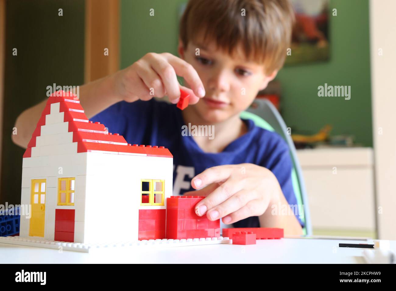 Symbol image: Boy builds a house with building blocks (Model released ...