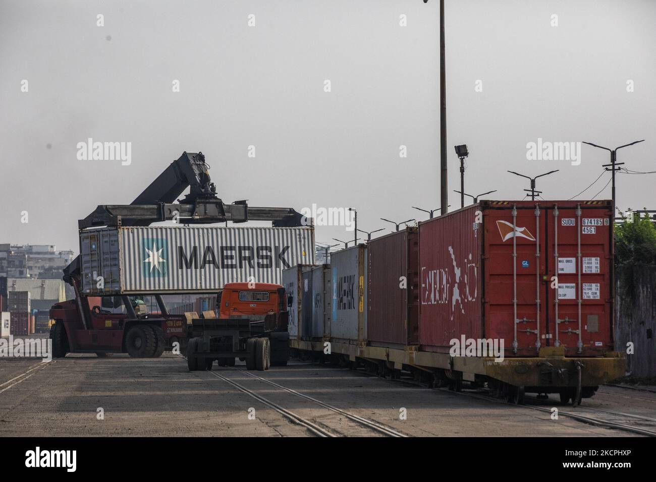 A reach stacker transports a container at the Kamlapur Inland Container ...