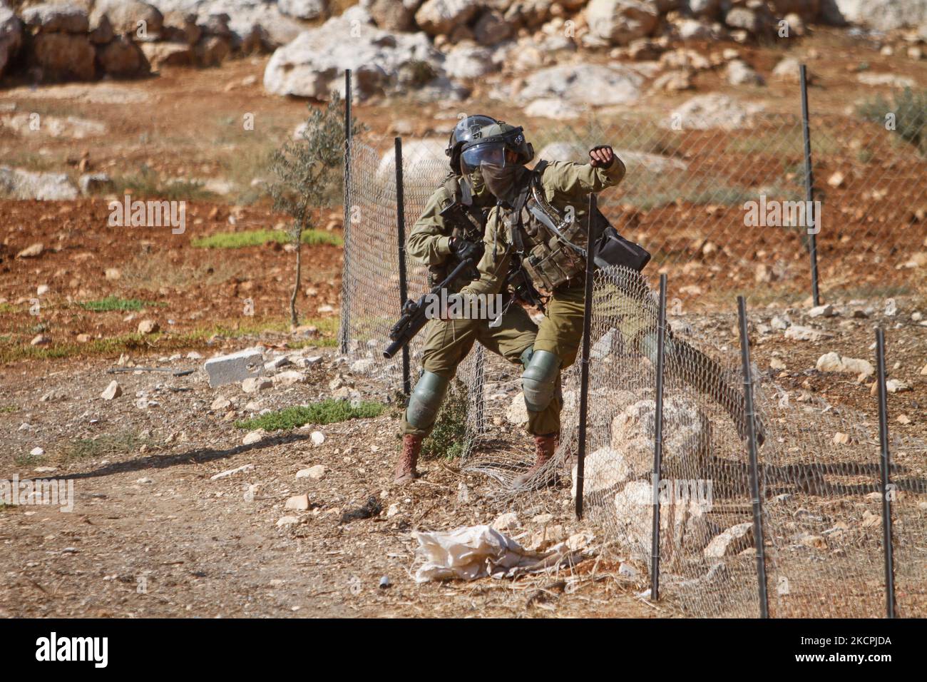 Israeli soldiers cross a check point between lands during the Palestinian demonstration against ...