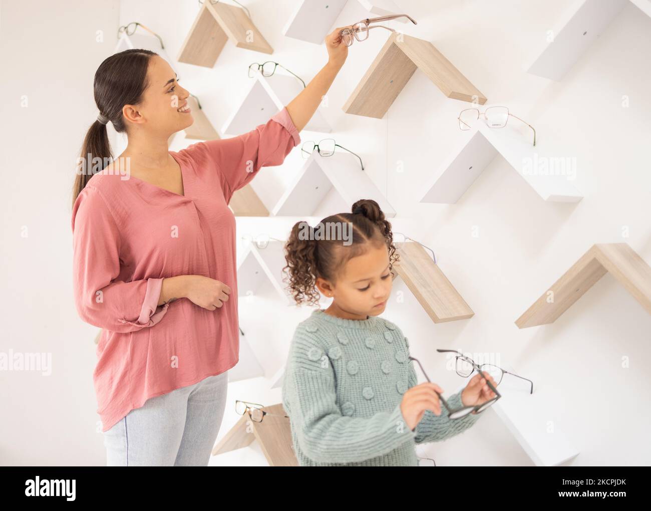 Glasses, decision and mother and child at an optometrist clinic for ...