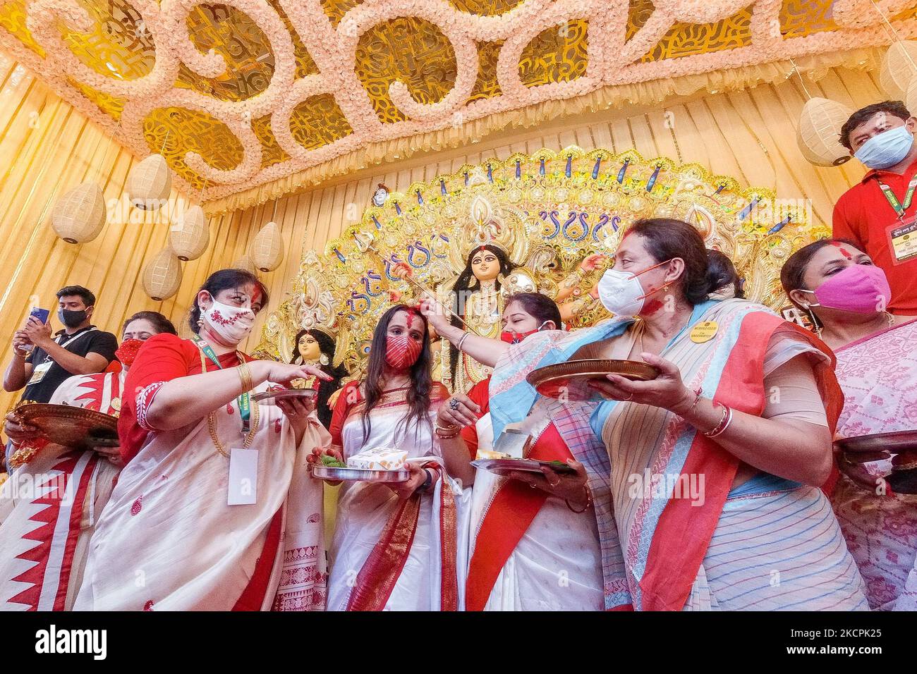 Married ladies smearing red sindur or vermilion , a ritual known as ...